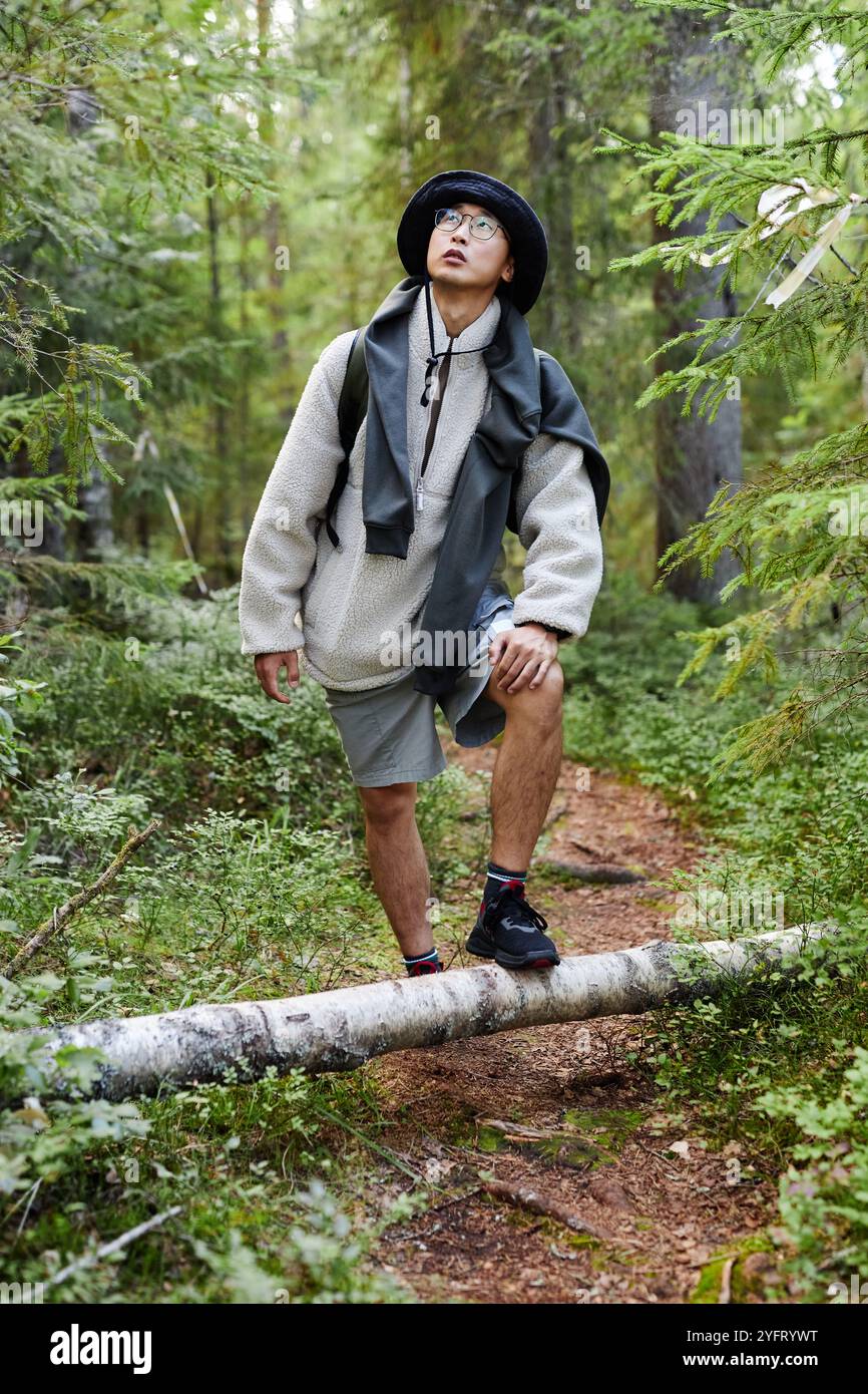 Vertical full length portrait of Asian young man travelling solo in ...