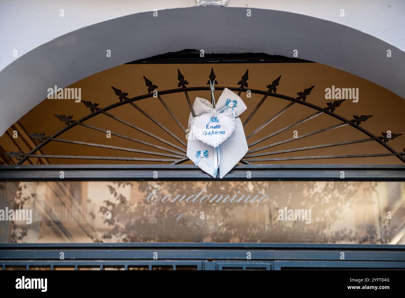 A ribbon with blue letters announces the birth of a baby boy in a house ...