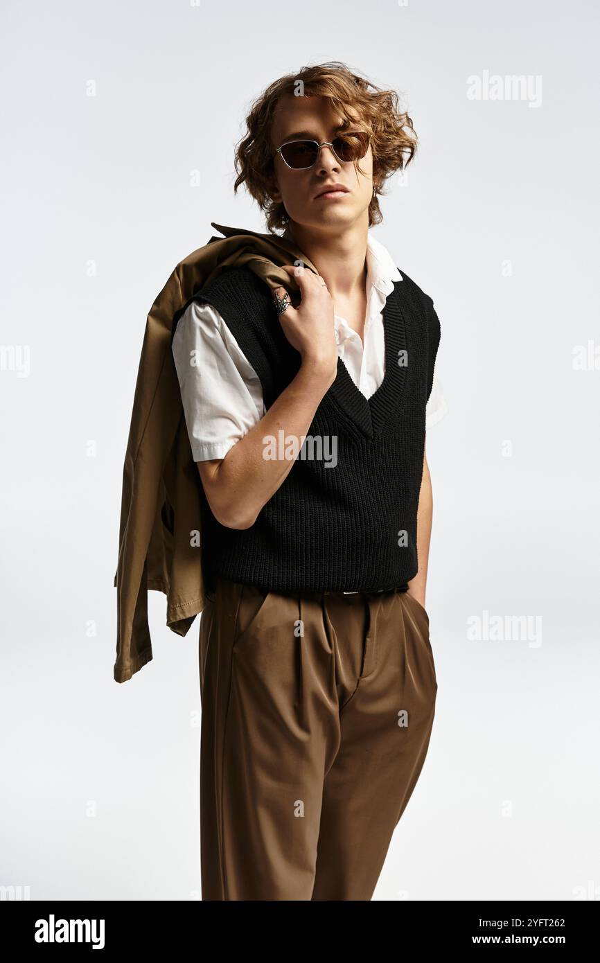 This handsome young man exudes charm in a chic autumn outfit, striking ...