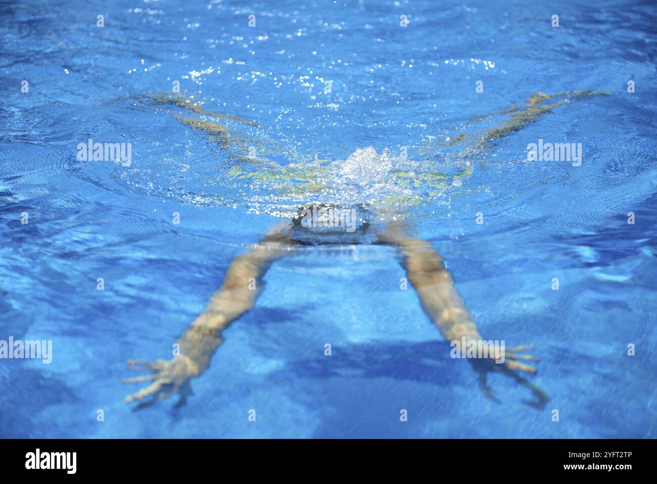 Fit swimmer training in the swimming pool. An overhead view of a man ...