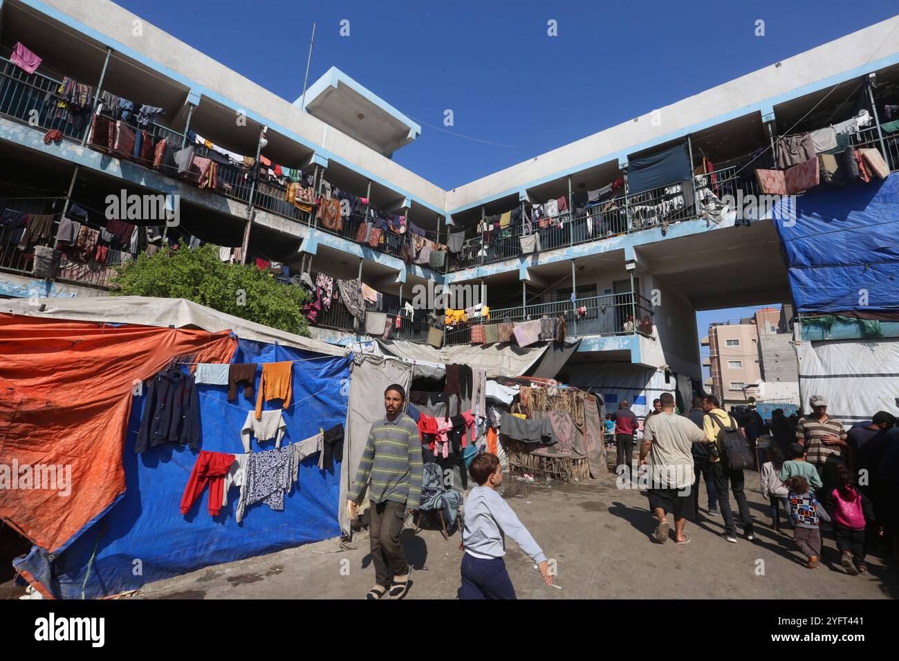 Palestinians take shelter in the UNRWA school, and the tents they have ...