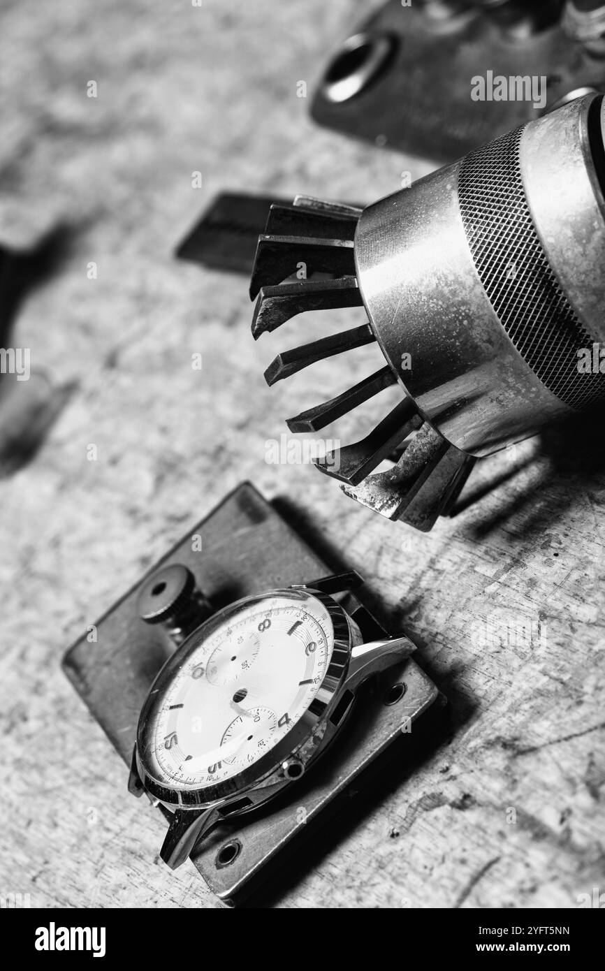 Black-and-white image displays a watchmaker's tool for detaching watch ...