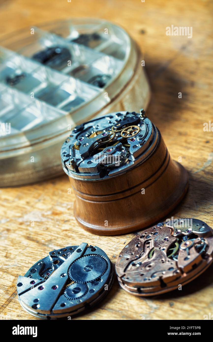 Intricate watch mechanisms displayed on a wooden surface showcase ...