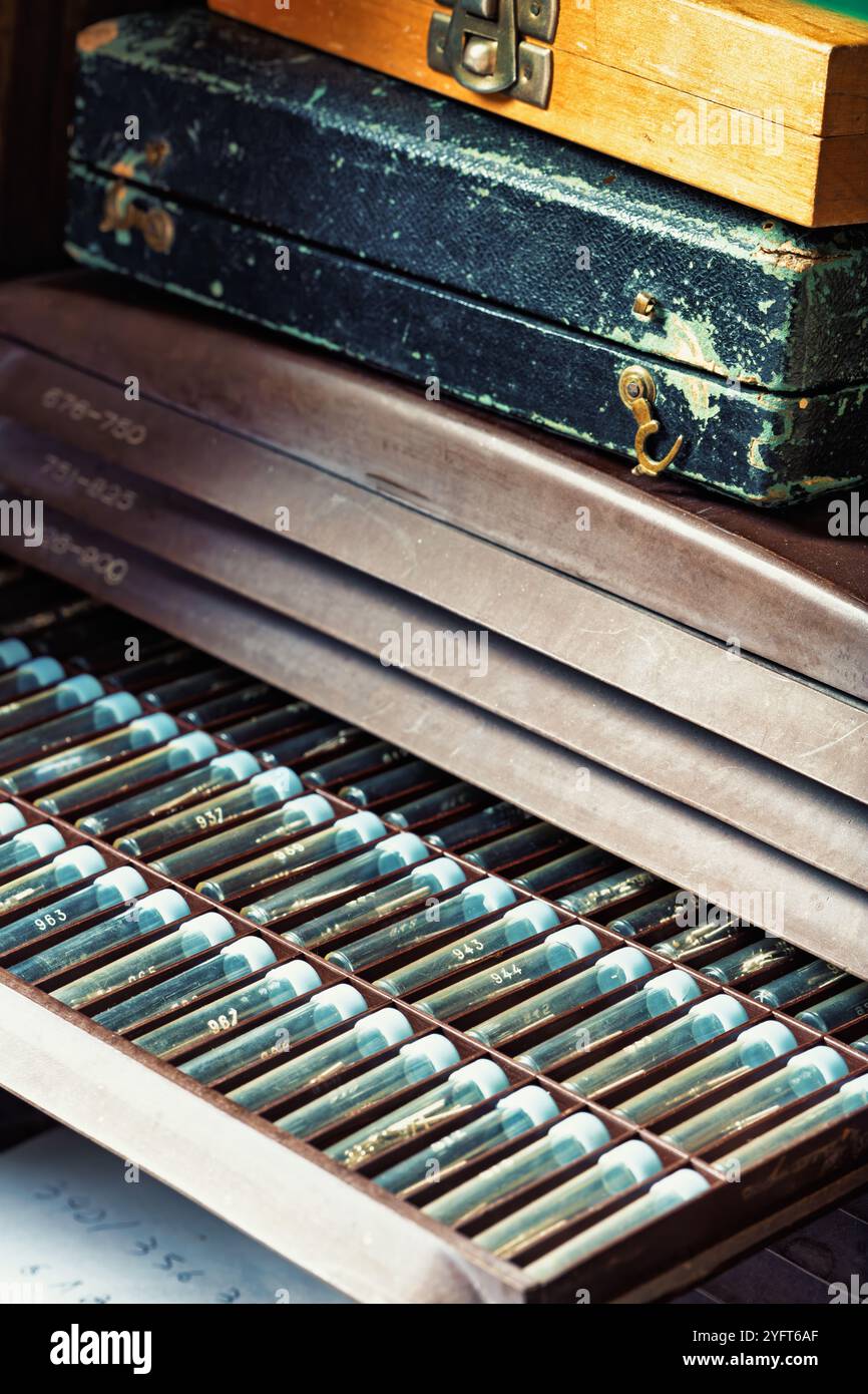 Organized drawer displays labeled tubes holding watch parts, with two ...