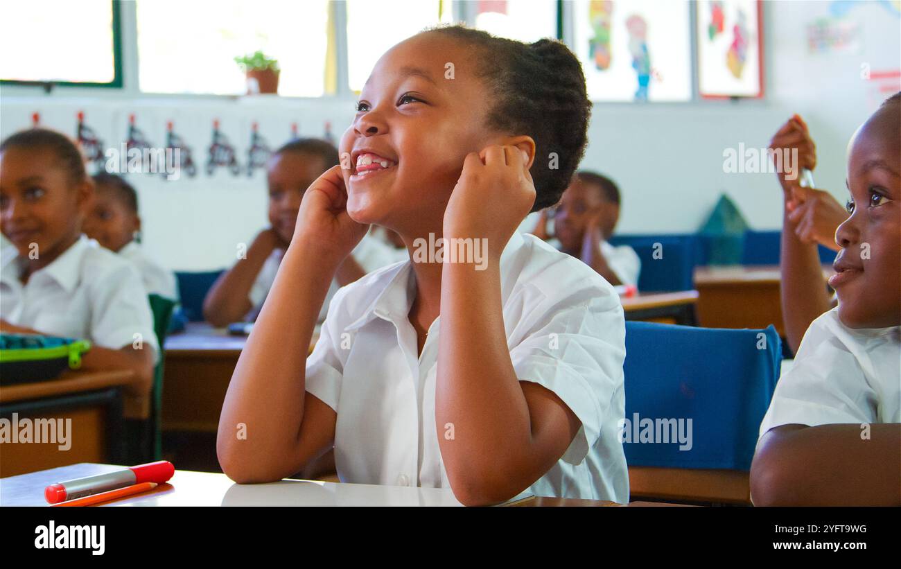 A schoolgirl smiles brightly while participating in class Stock Photo ...