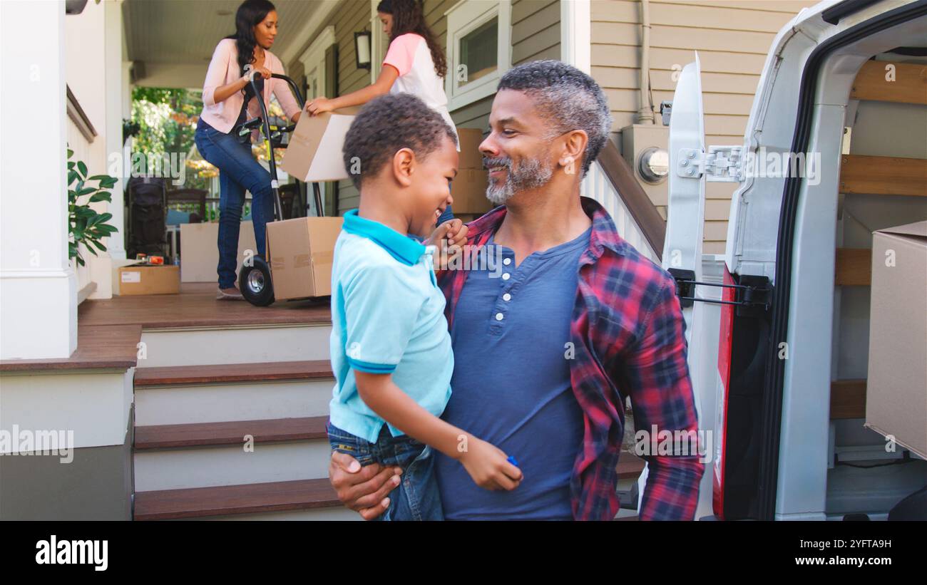 Family With Children Packing Boxes Into Van On Moving Day Stock Photo ...