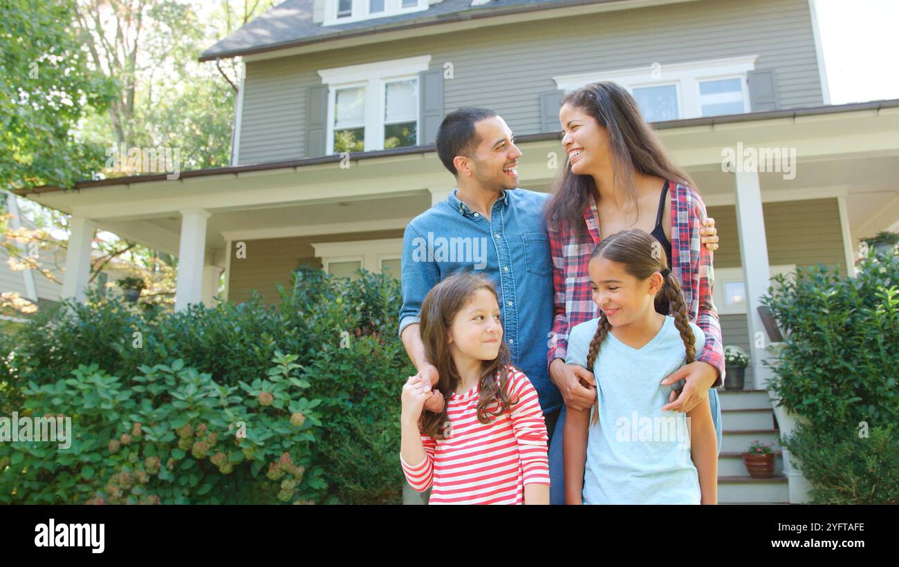 Portrait Of Smiling Family Standing In Front Of Their Home Stock Photo ...