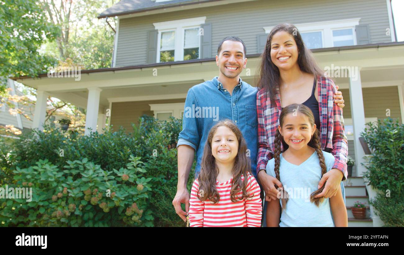 Portrait Of Smiling Family Standing In Front Of Their Home Stock Photo ...