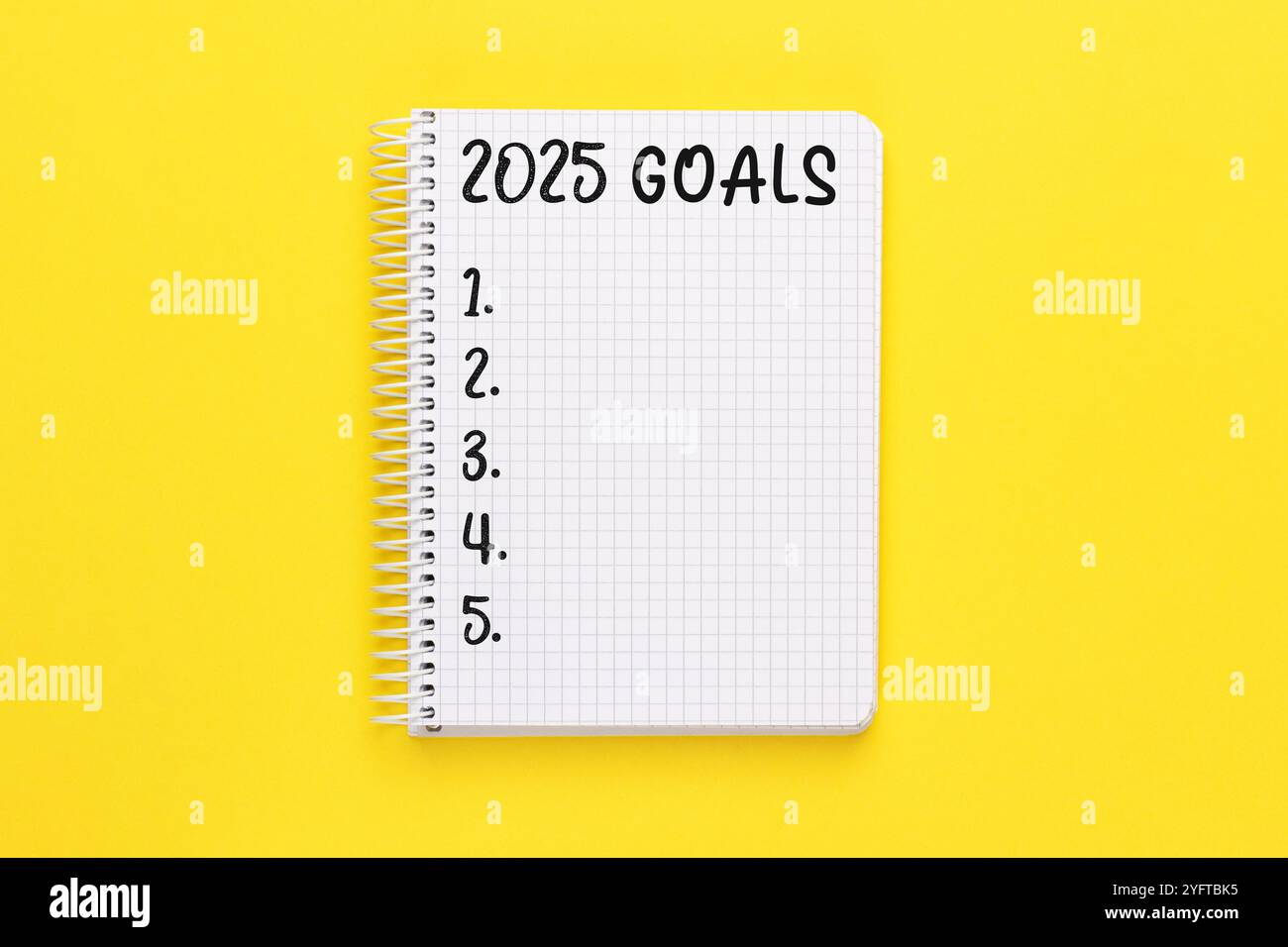 Notebook with 2025 Goals on bright yellow background, spiral bound ...