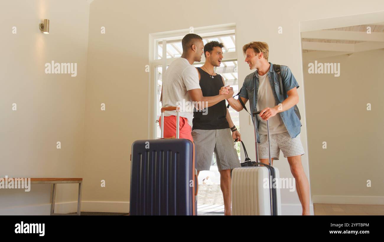 Group Of Male Friends With Luggage Arriving At Summer Vacation Rental ...