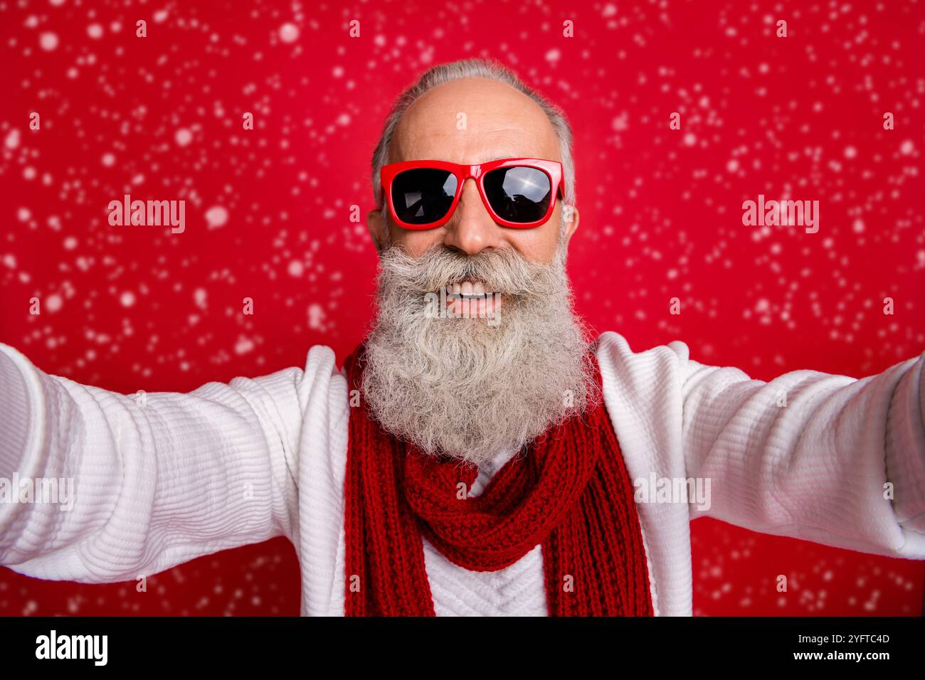 Excited aged santa man making self photos wear sun specs knitted jumper ...