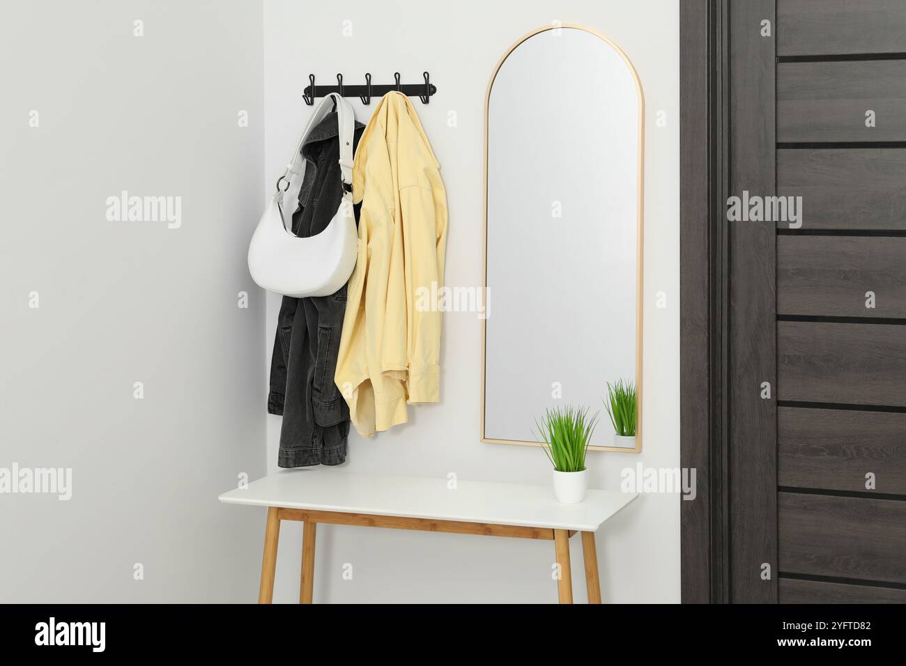 Mirror, rack with clothes and shoe storage bench in hallway. Interior ...