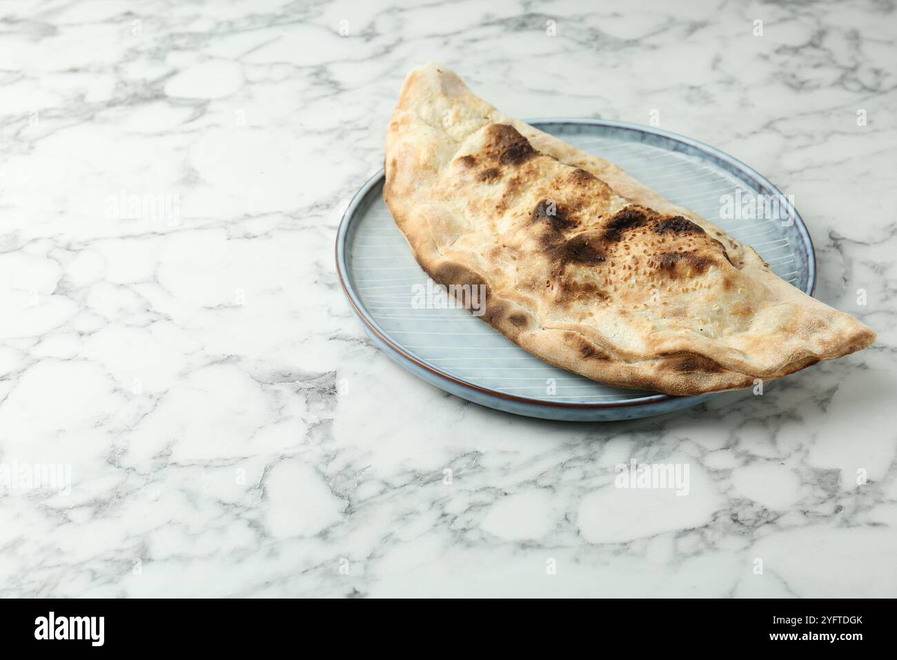 Delicious calzone on white marble table. Space for text Stock Photo - Alamy