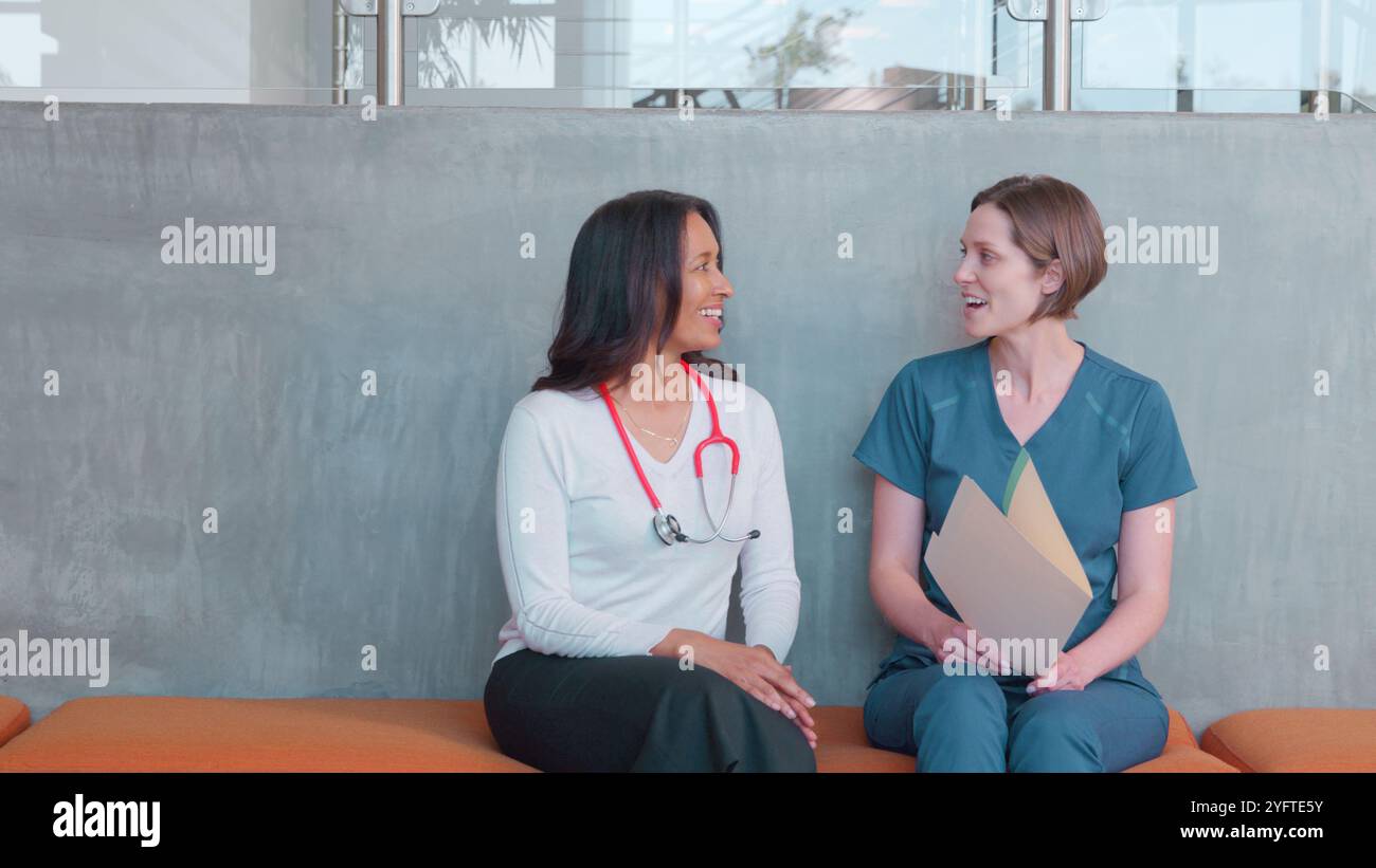 Two Female Members Of Medical Or Surgical Team Wearing Scrubs Meeting ...