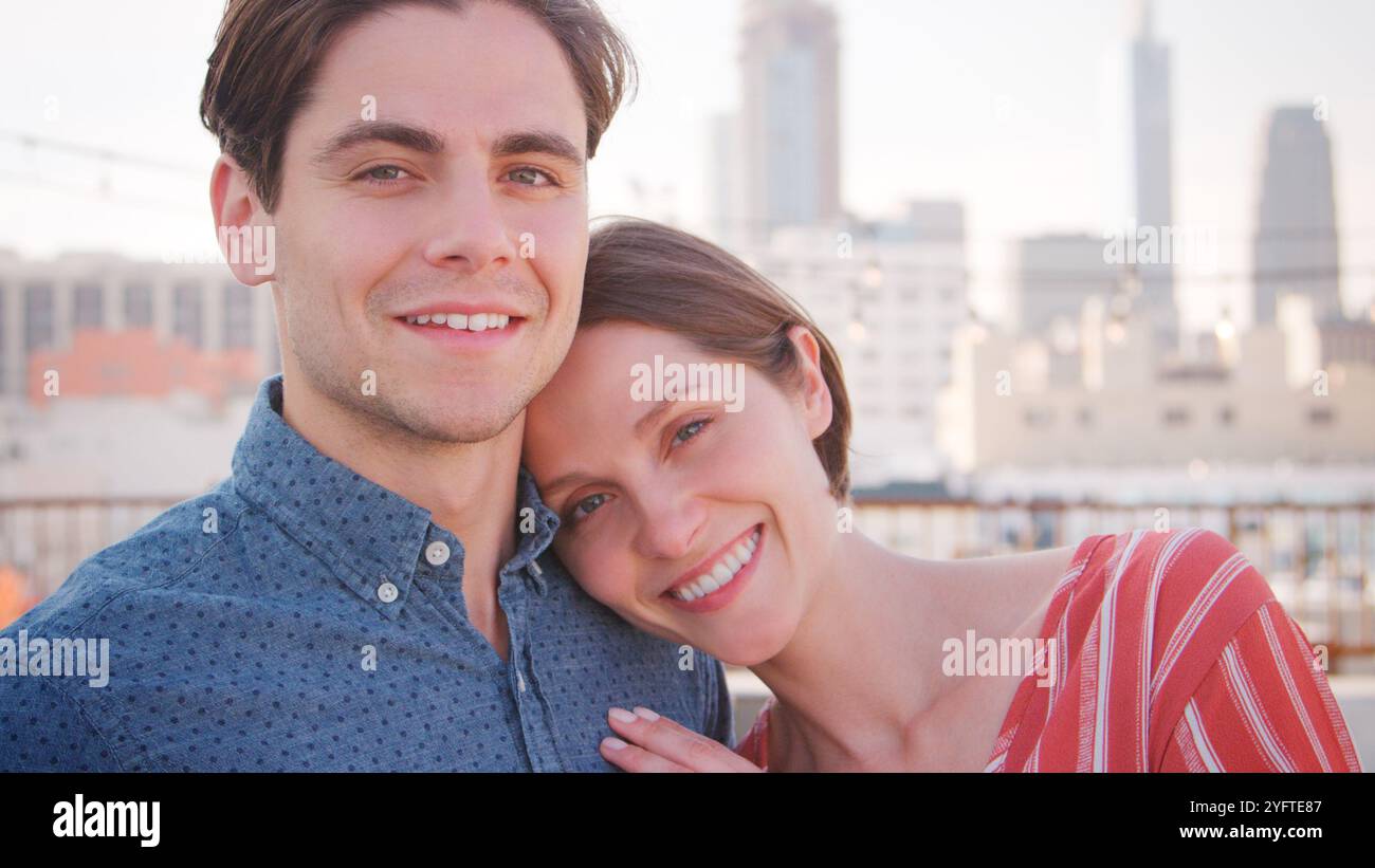 Portrait Of Romantic Couple Hugging On Rooftop Terrace With City ...