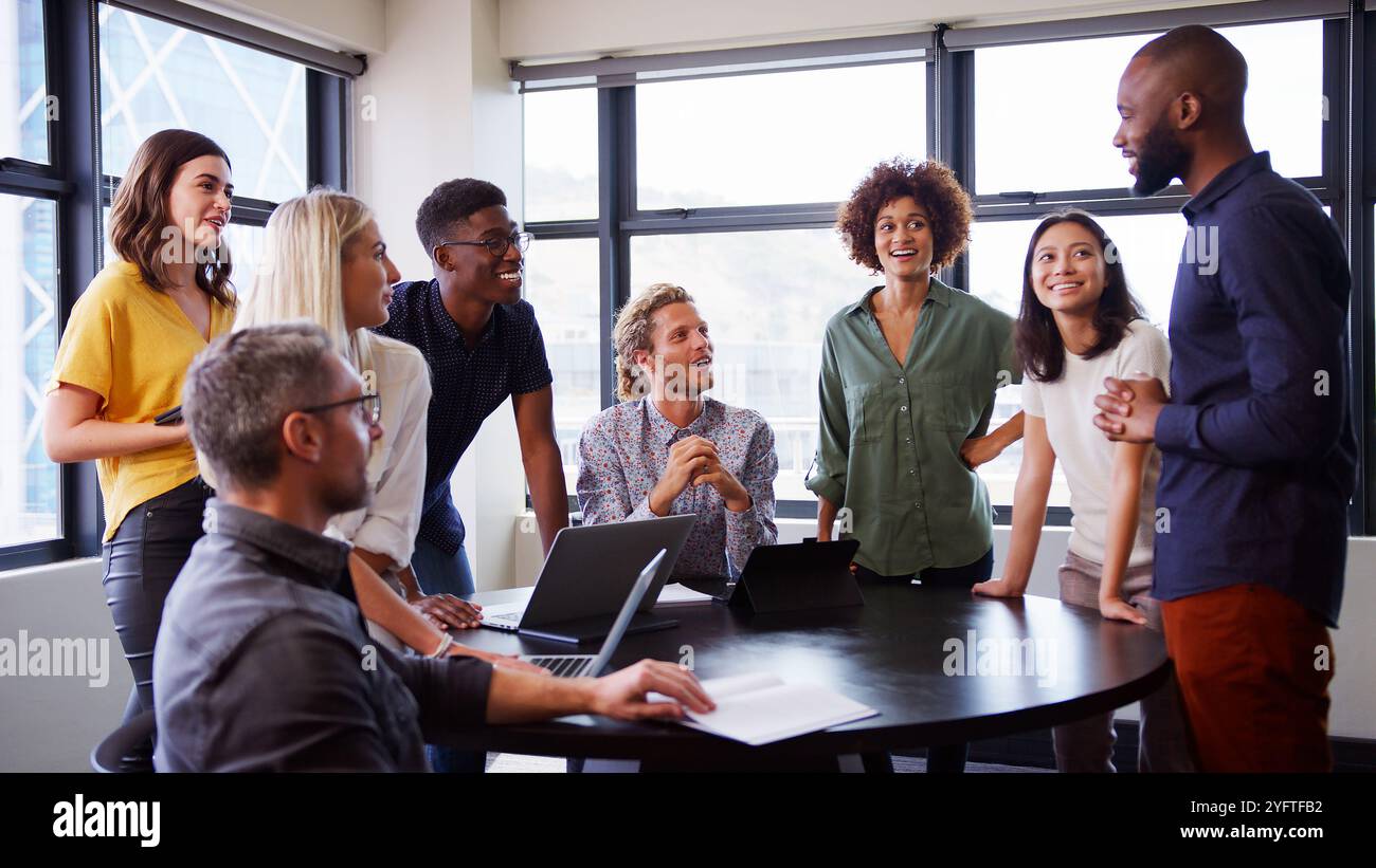 Multi-Cultural Business Team Meeting And Collaborating Around Table In ...