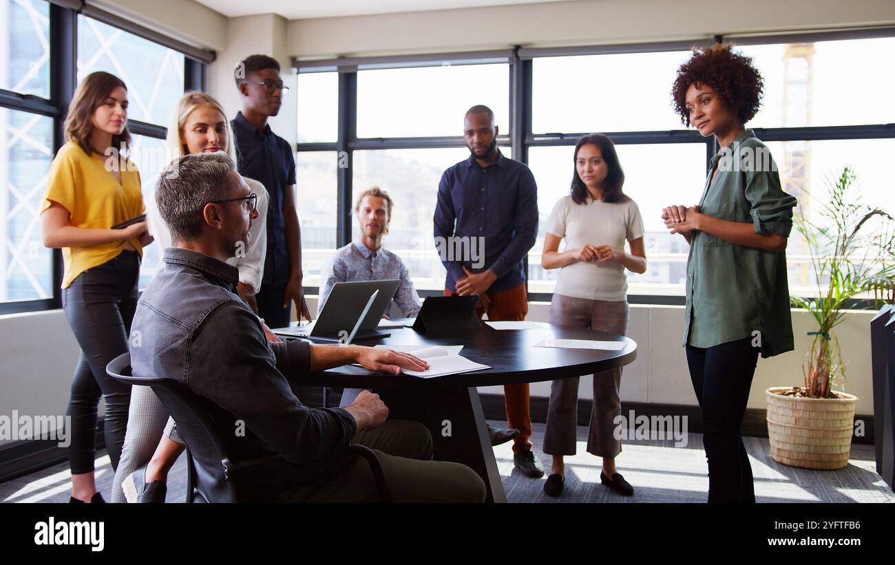 Multi-Cultural Business Team Meeting And Collaborating Around Table In ...