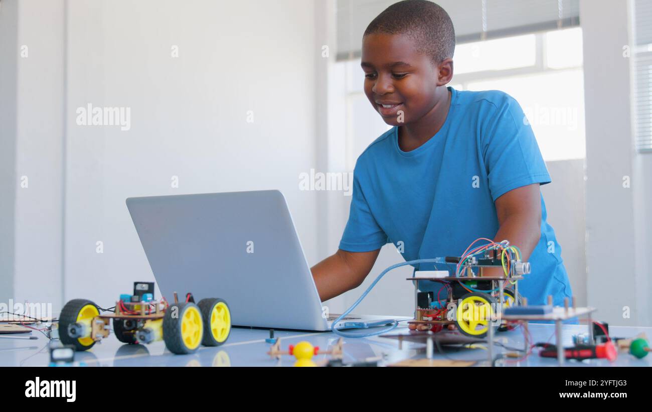 Male Student Building And Programming Robot Vehicle In After School Computer Coding Class Stock ...
