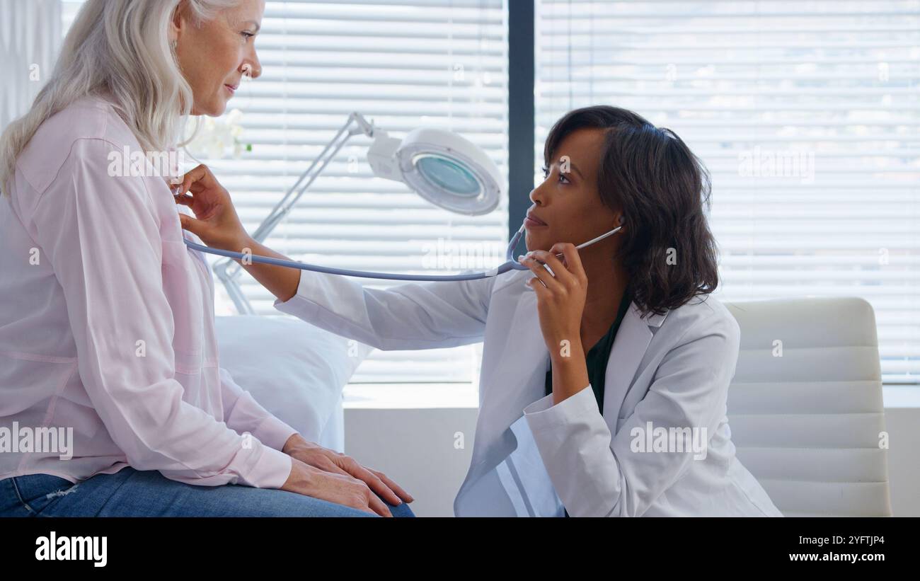 Doctor Listening To Mature Female Patient Breathing With Stethoscope ...
