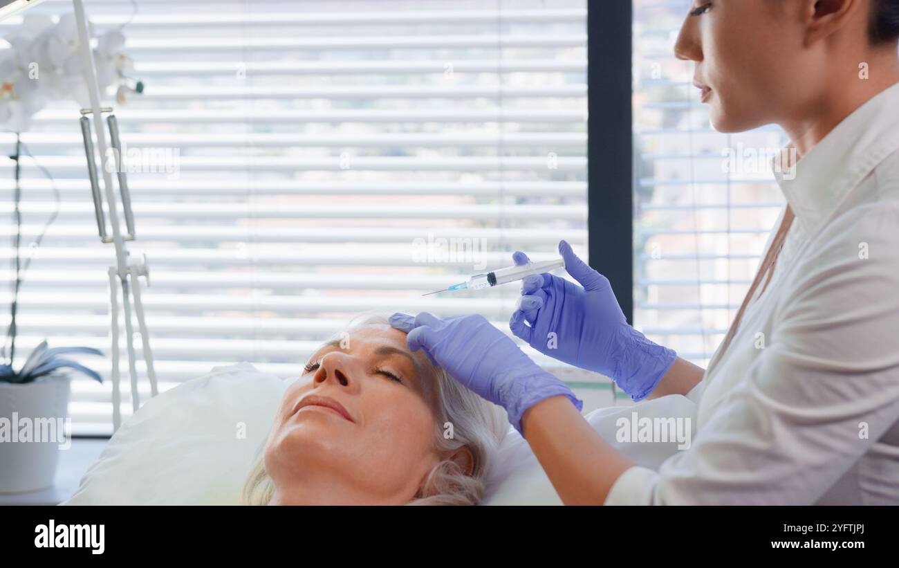 Close Up Of Beautician Giving Mature Female Patient Botox Injection In ...