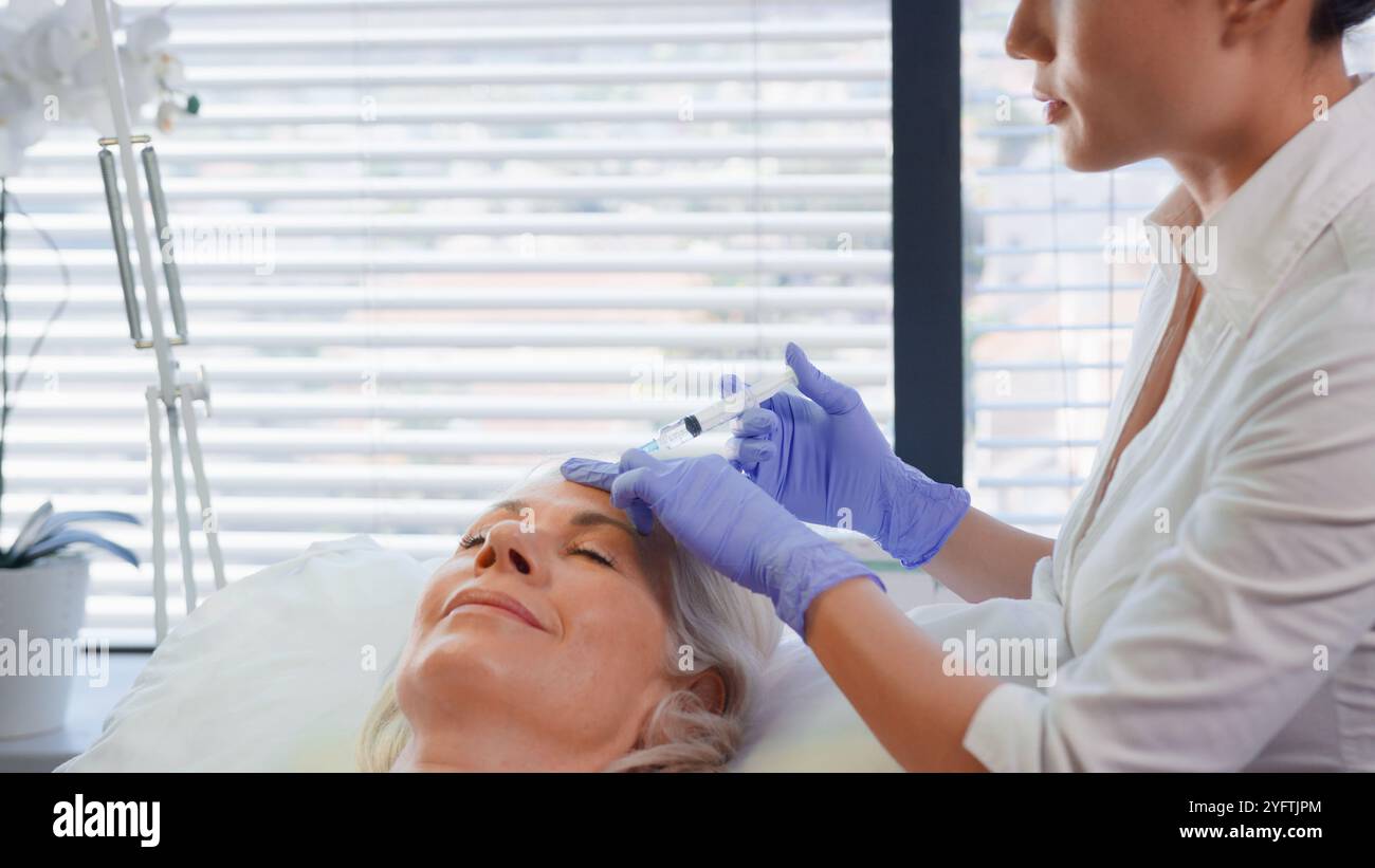 Close Up Of Beautician Giving Mature Female Patient Botox Injection In ...