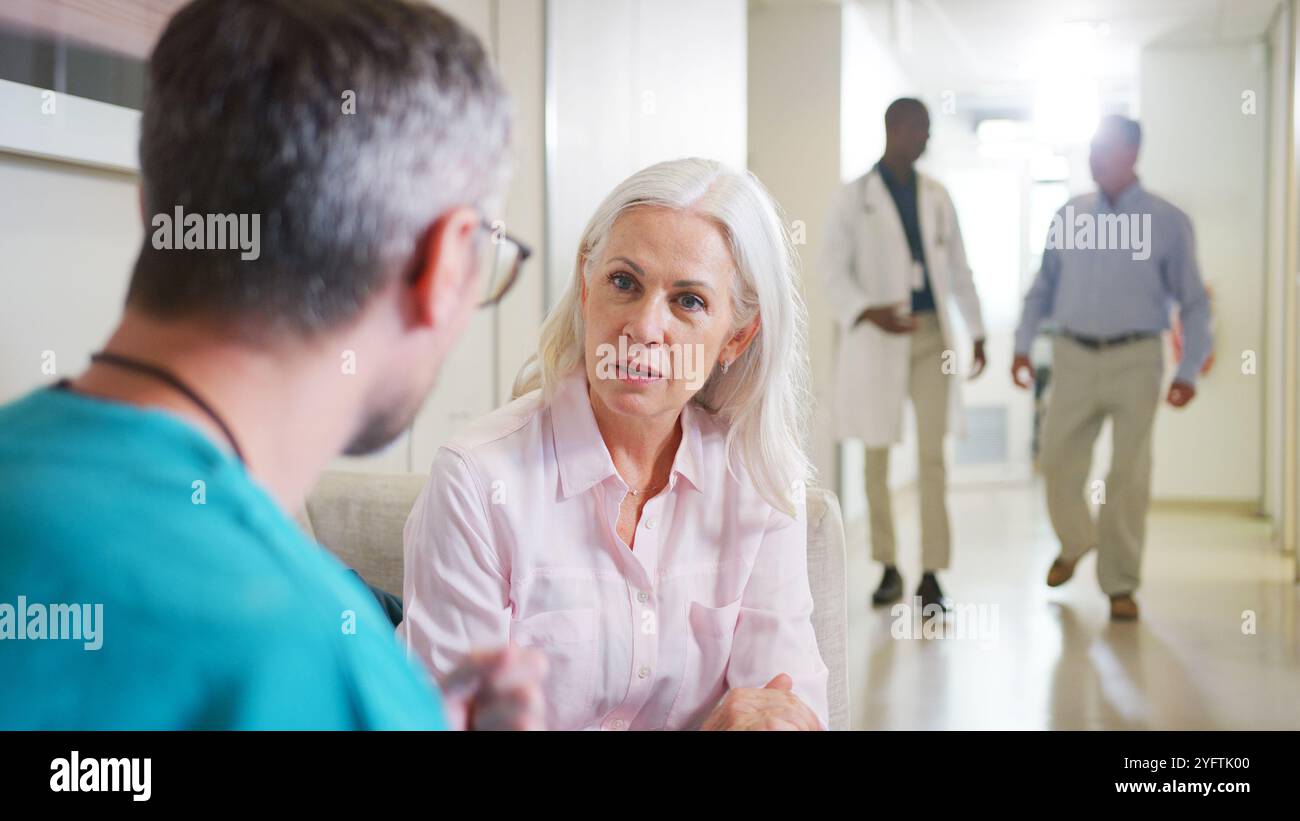 Doctor Having Serious Conversation With Mature Woman In Hospital ...