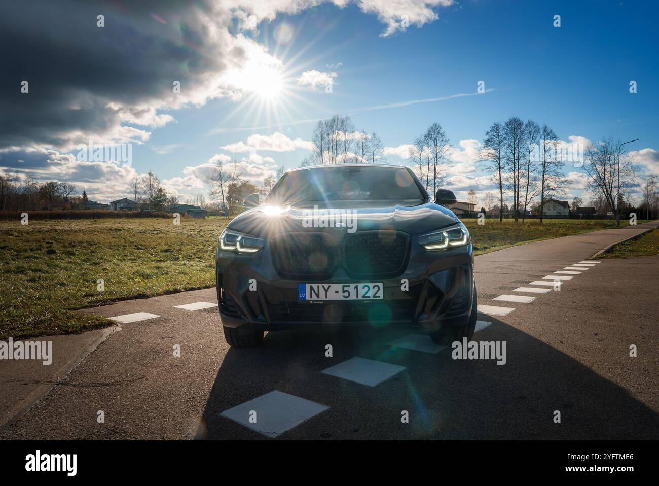 BMW X4 on Paved Road with Open Fields and Sparse Trees Stock Photo - Alamy