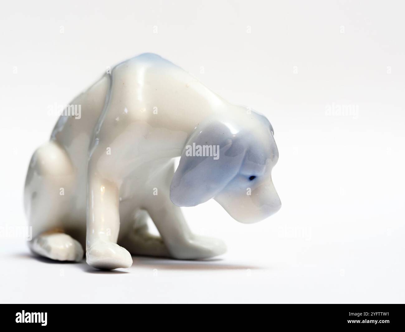 In tis photoillustration Vintage porcelain figurine of dog on white ...