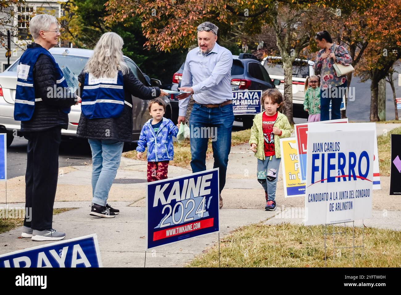 Election day 2024 in Virginia. Poll greeter hands sample ballot to ...