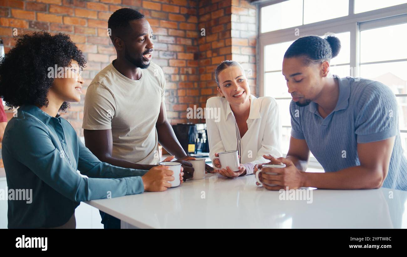 Multi-Cultural Businessmen Taking Coffee Break In Kitchen Area Of ...