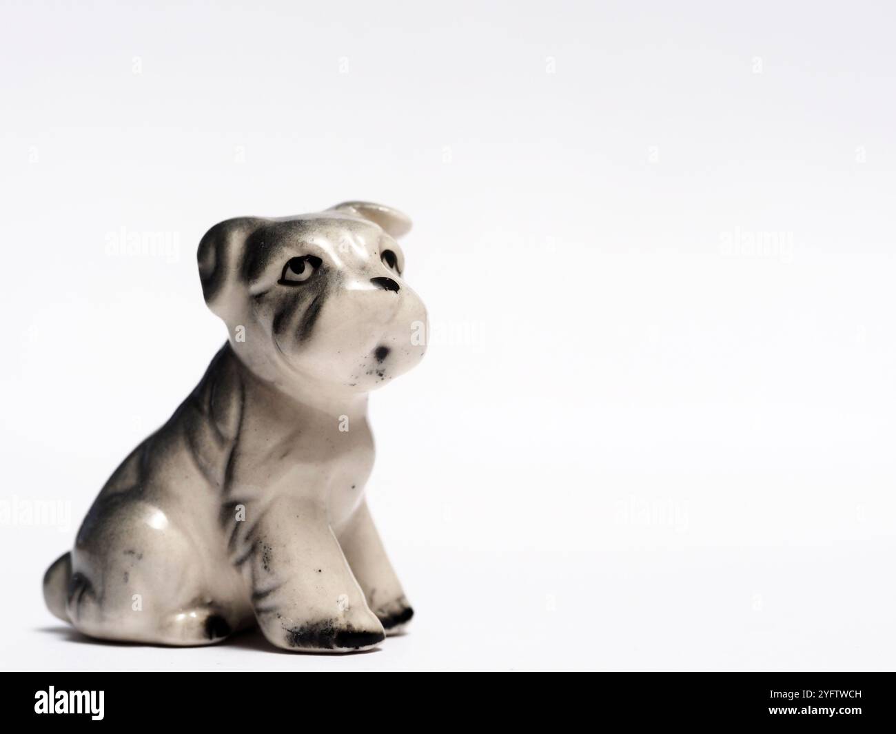 In tis photoillustration Vintage porcelain figurine of dog on white ...