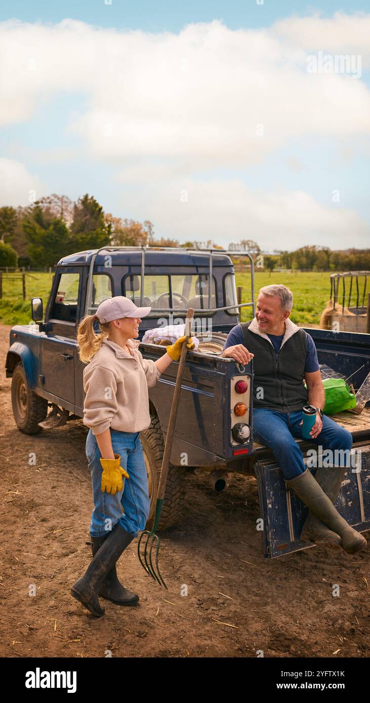 Mature Male Farm Worker Sitting On Tailgate Of Off Road Farm Vehicle ...