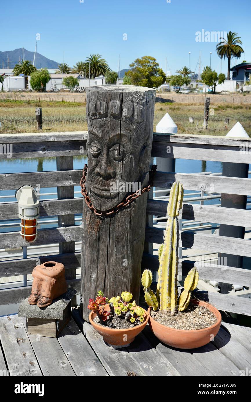 Carved wooden post and plants on a jetty in the harbor Stock Photo - Alamy