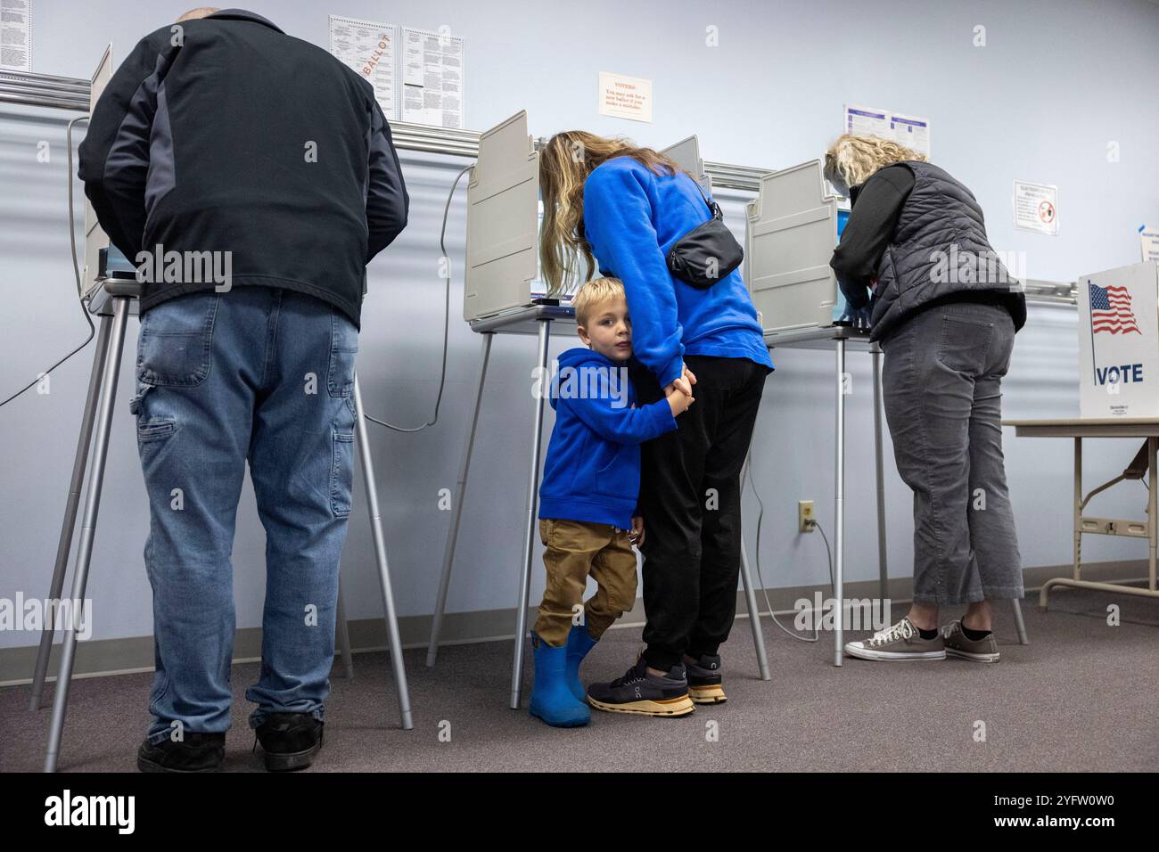 Katie Goeling, center, fills out her ballot while her son Gunner, 4 ...