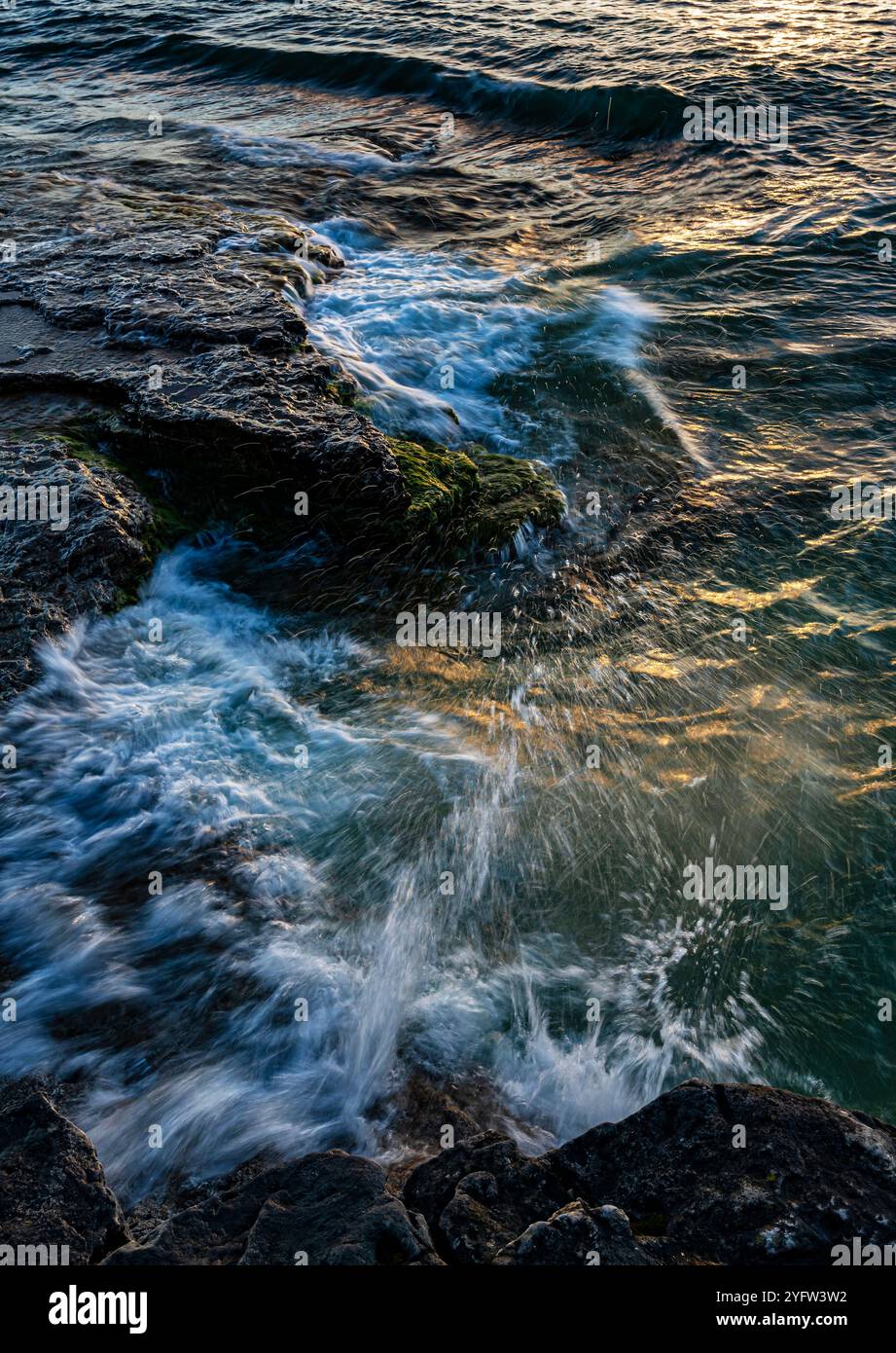 Waves crash the Lake Michigan shore creating interesting patterns of ...