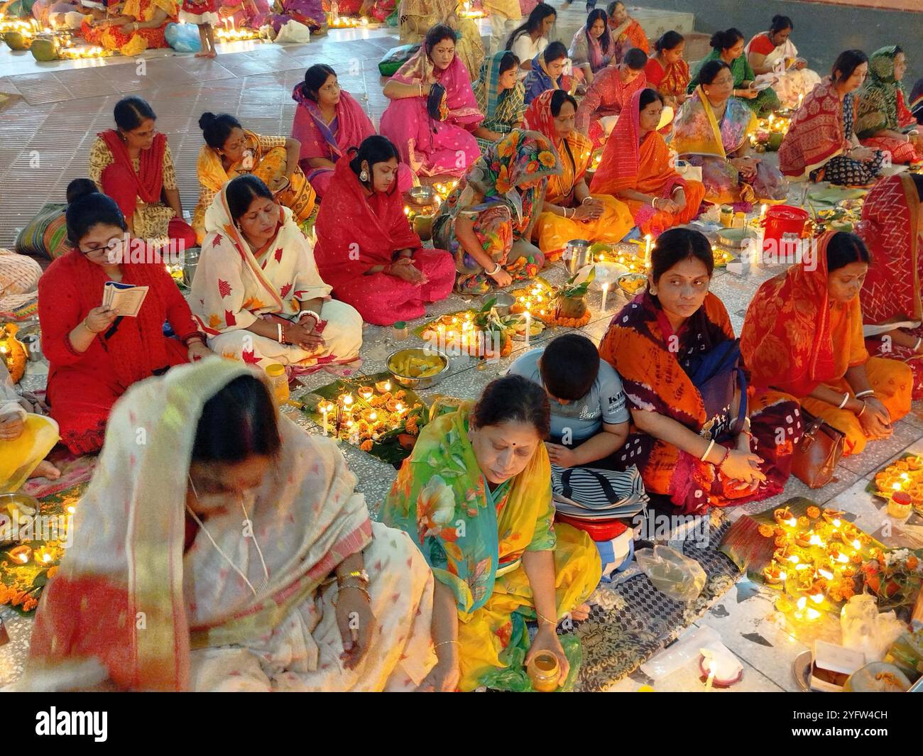 Dhaka, Bangladesh. 5th Nov, 2024. Hindu devotees sit on the floor ...
