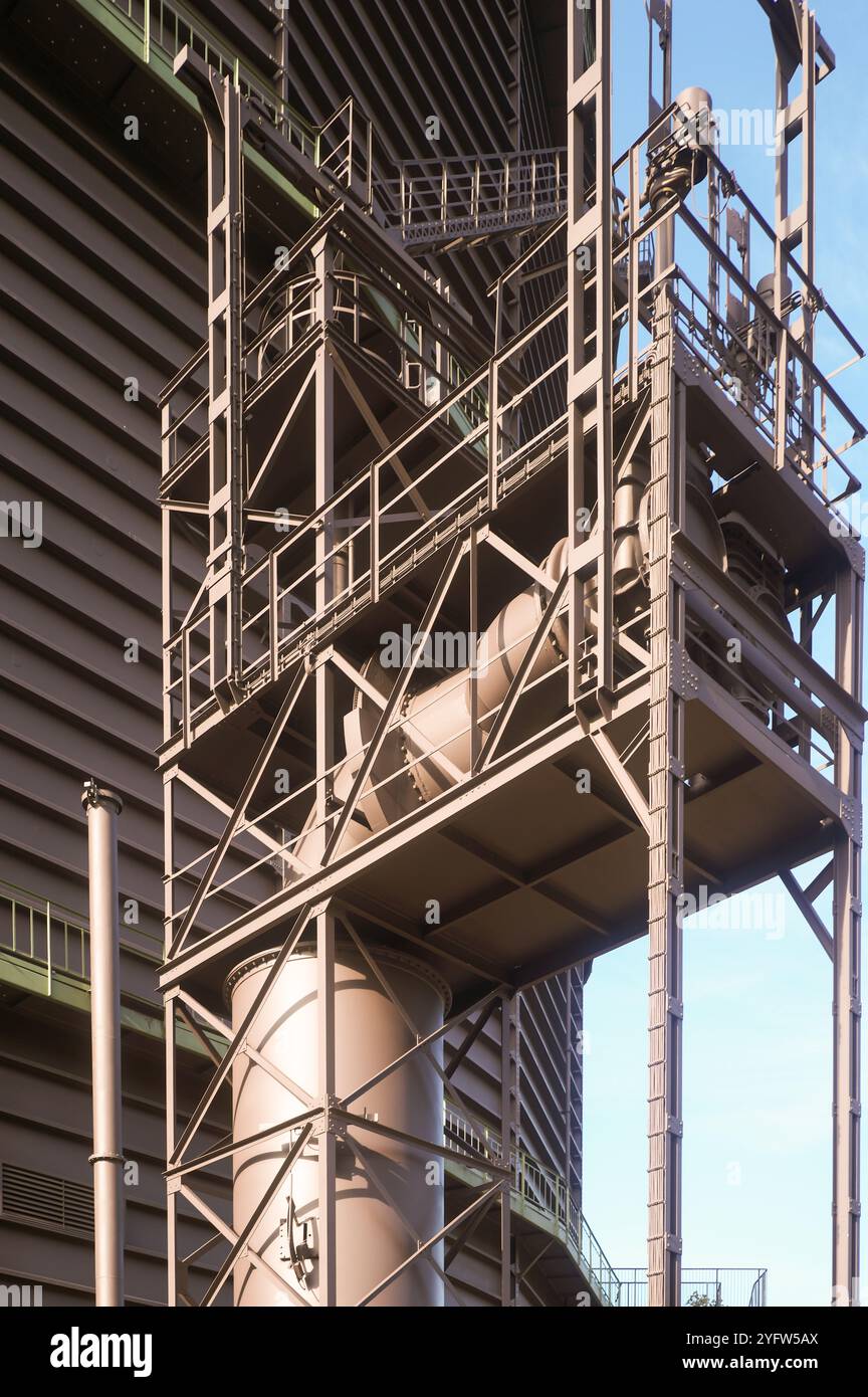 Metal pipes, platforms, and support structures create an industrial ...