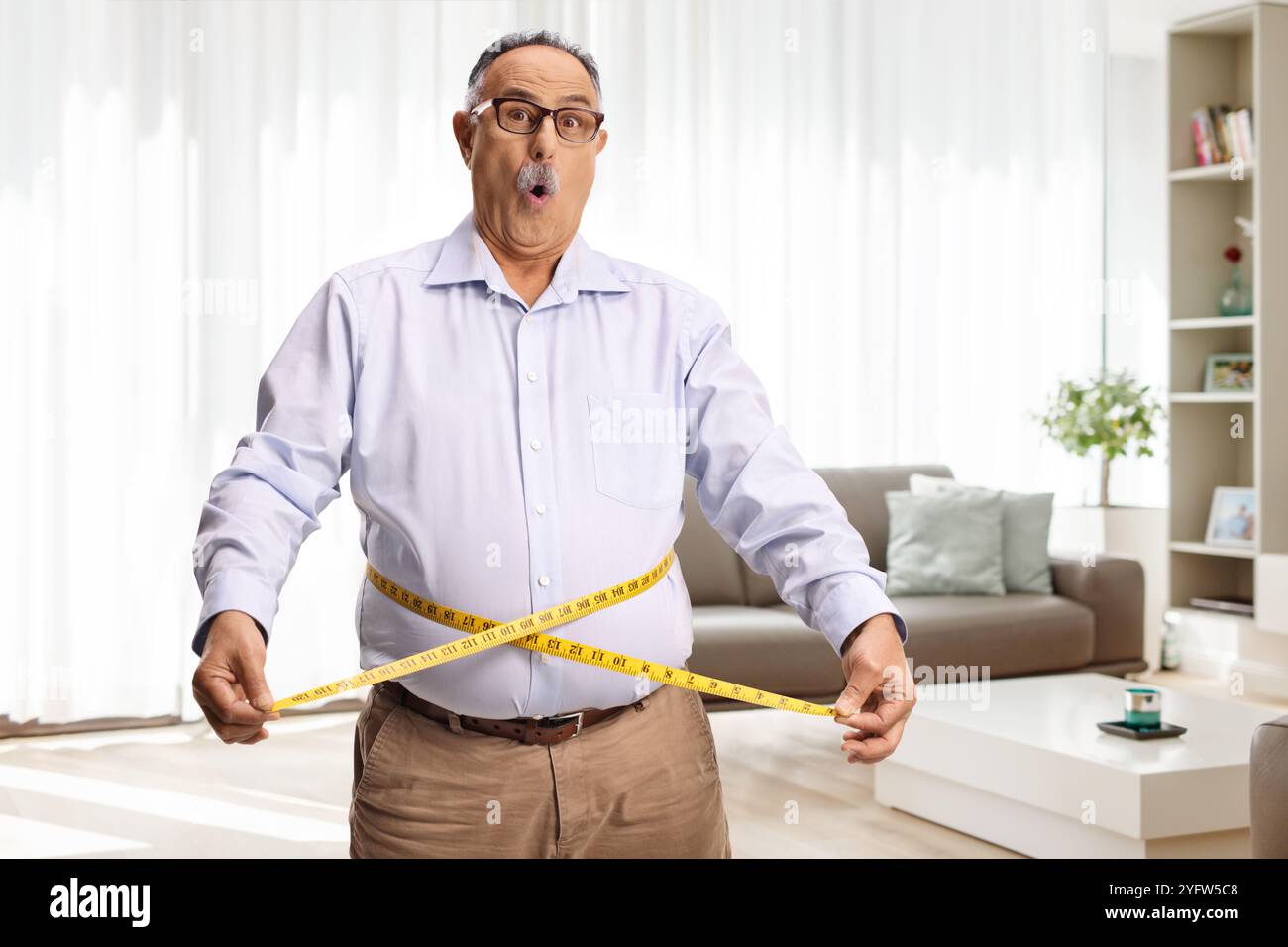 Fat man measuring belly hi-res stock photography and images - Alamy