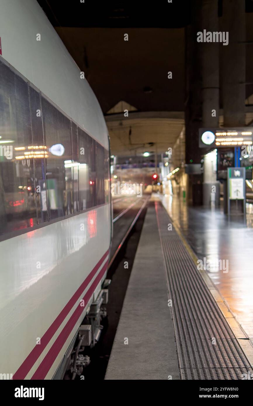 Modern train at illuminated railway station platform Stock Photo - Alamy