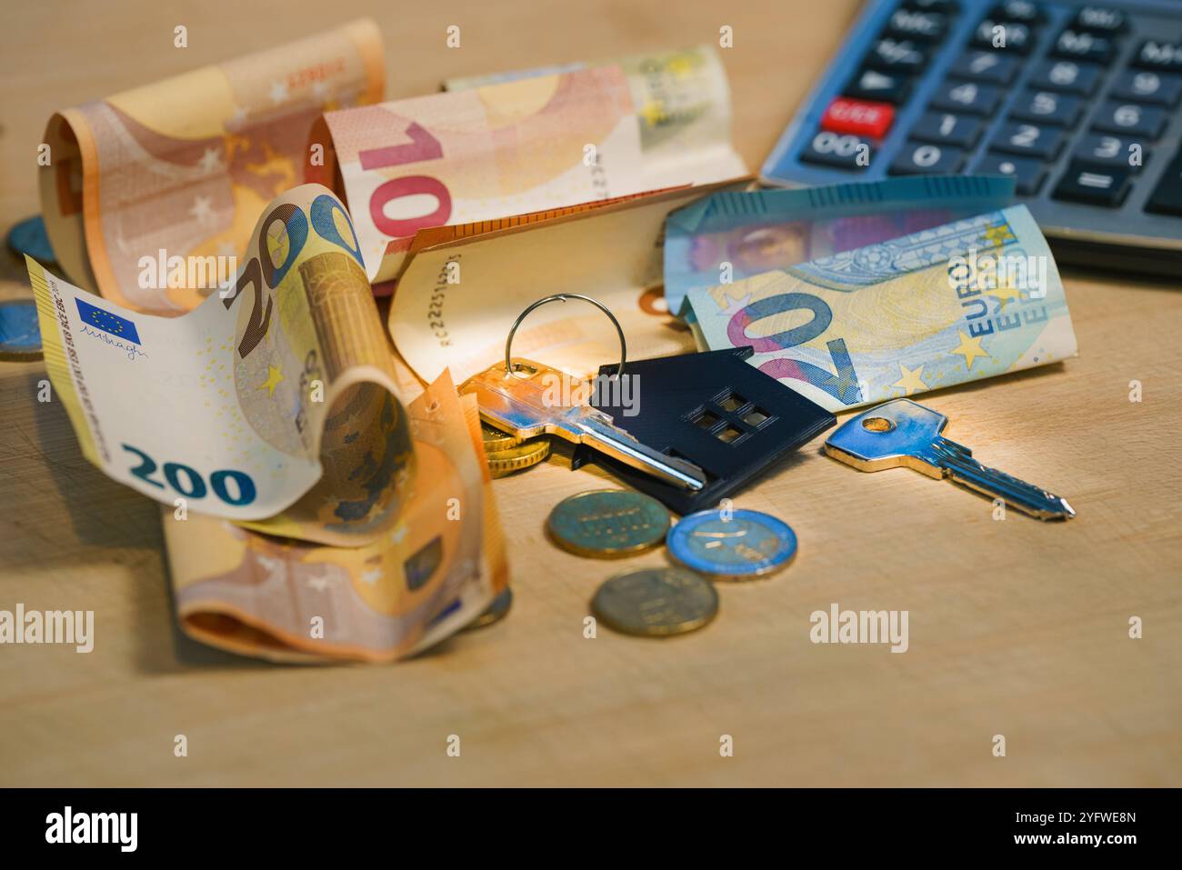 door keys home savings money banknotes coins in table calculator Stock ...