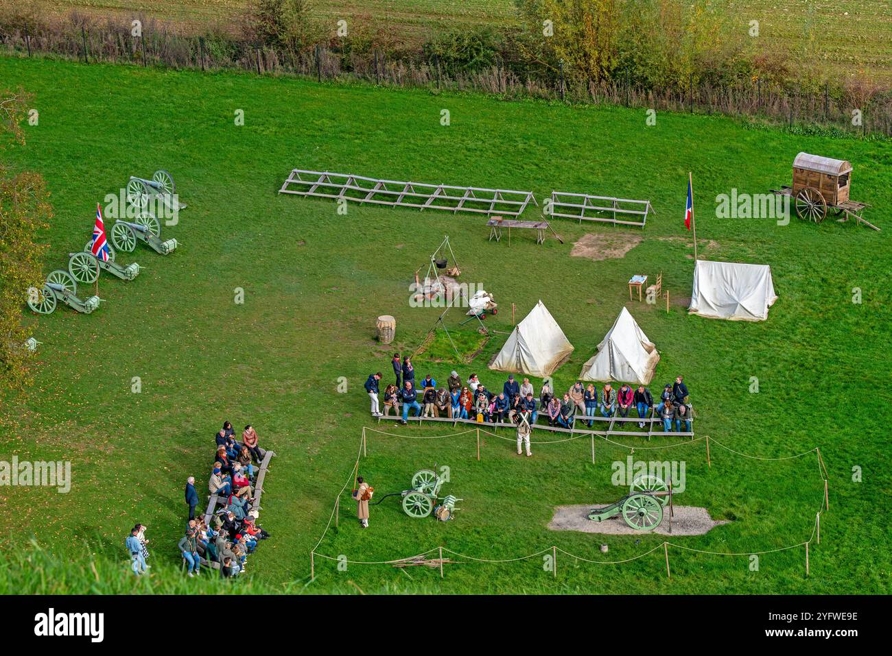 Tourists watching Napoleonic war reenactors firing cannon at the Domain ...