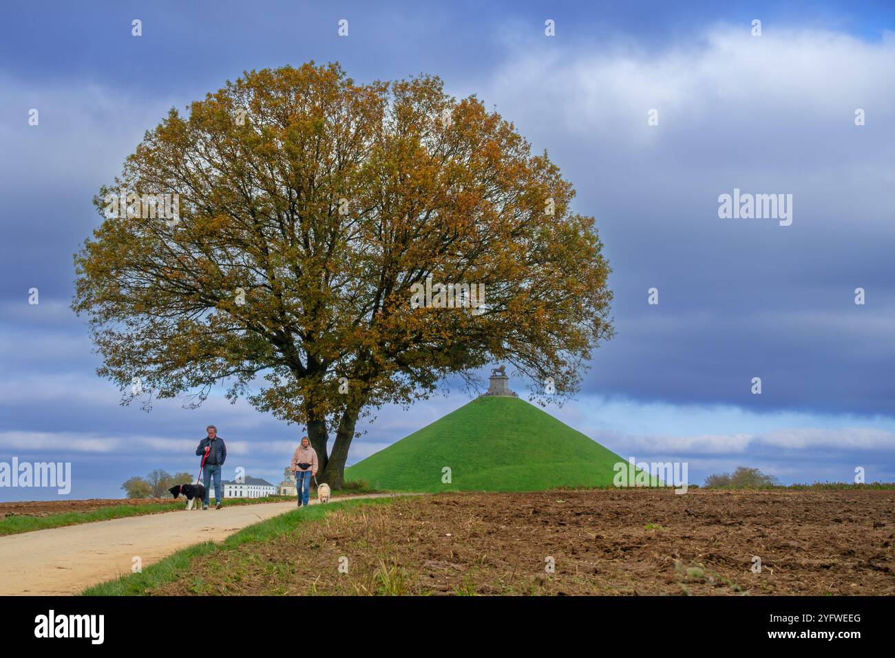 Lion's Mound and walkers walking along the English Lines, ridge held by ...
