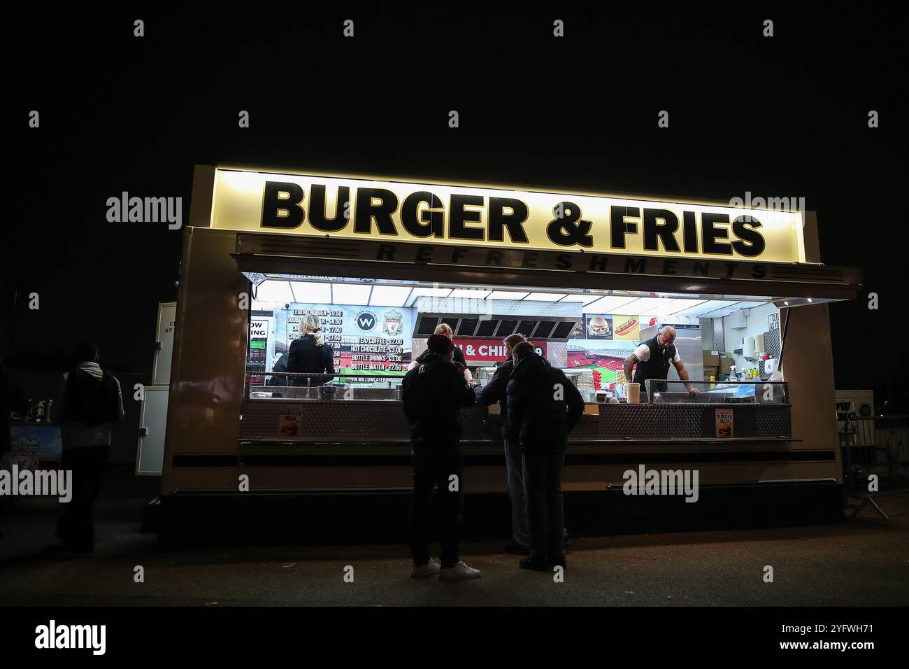 Fans grab a bite to eat outside Anfield during the UEFA Champions ...