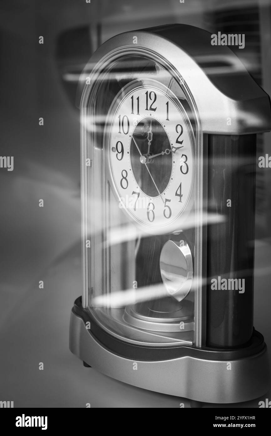 Vintage table clock without alarm on a table. View through the window ...