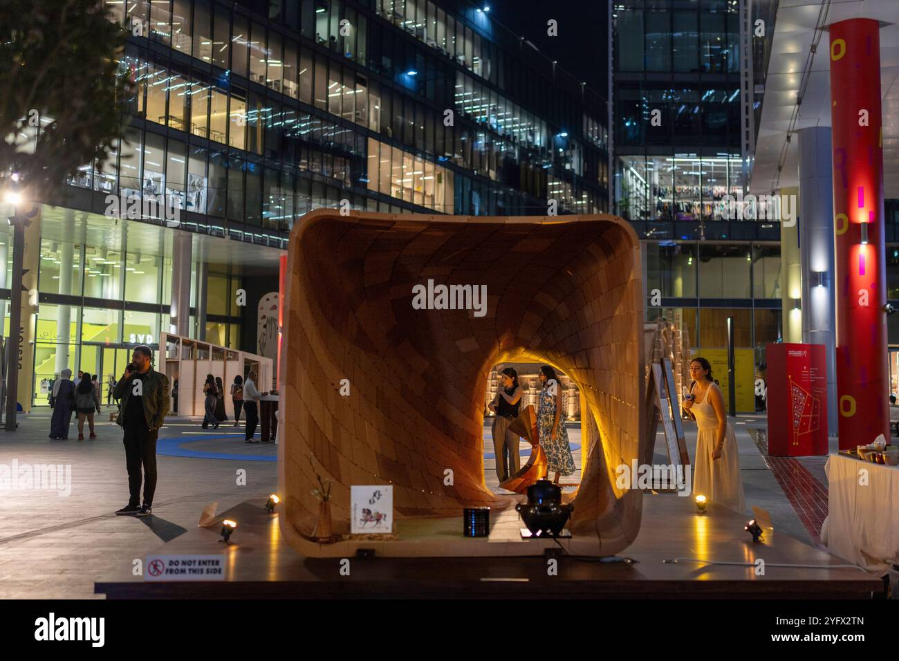 Visitors look at an art installation titled "The WARP" by Japanese by ...