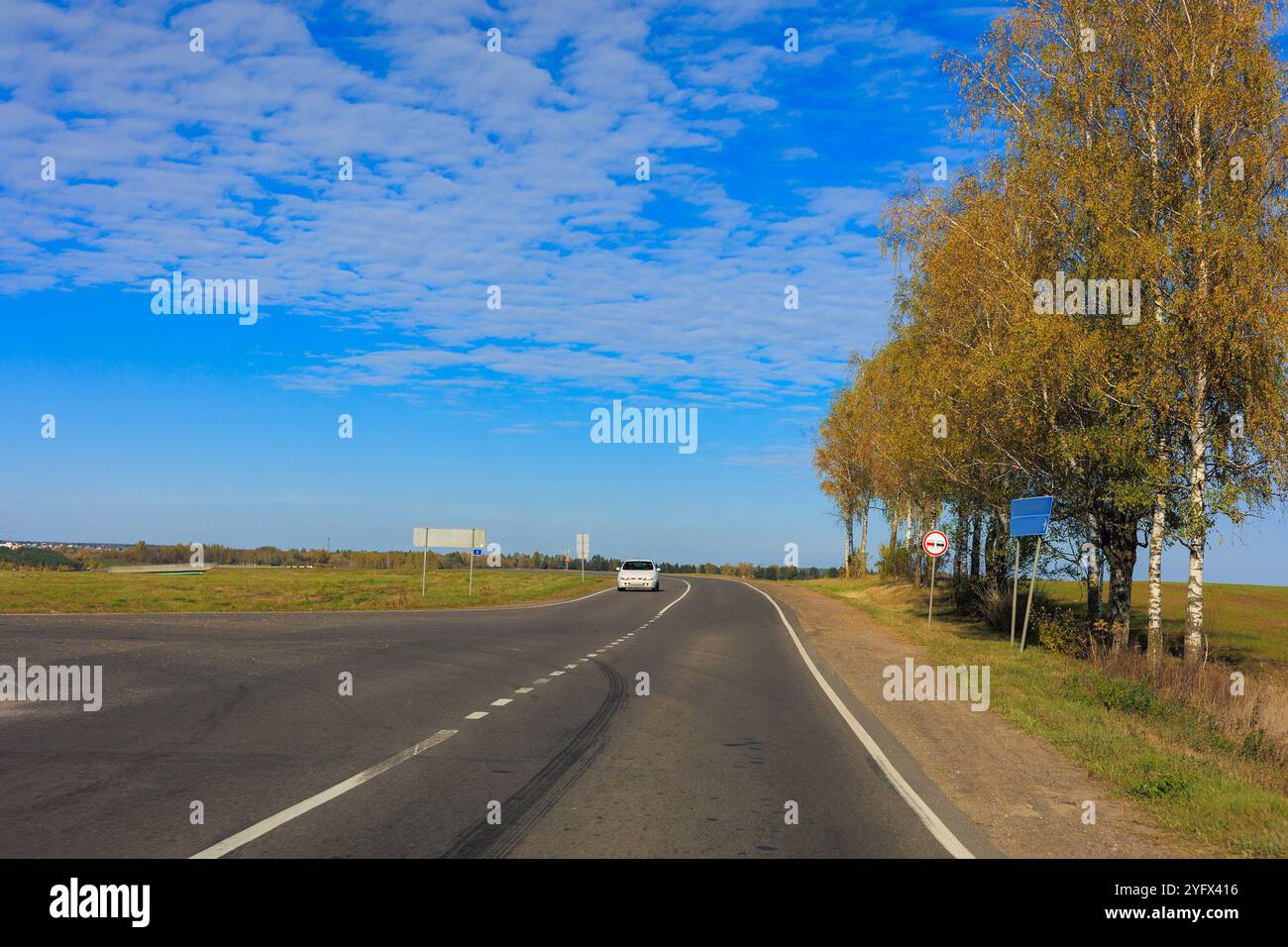 Evening view at sunset. Highway road in the countryside, roadside and ...