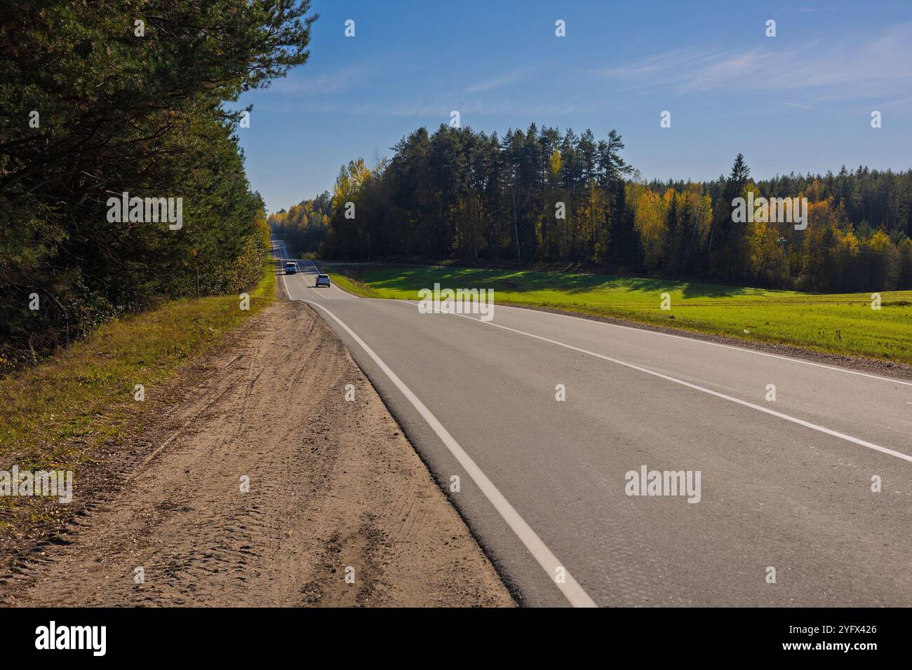 Evening view at sunset. Highway road in the countryside, roadside and ...