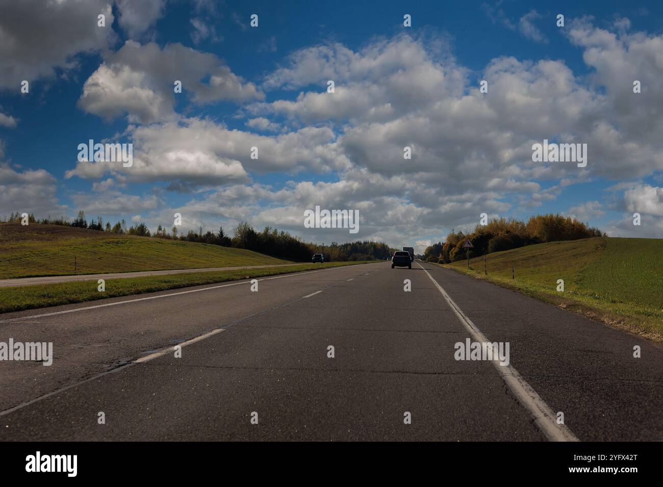 Evening view at sunset. Highway road in the countryside, roadside and ...