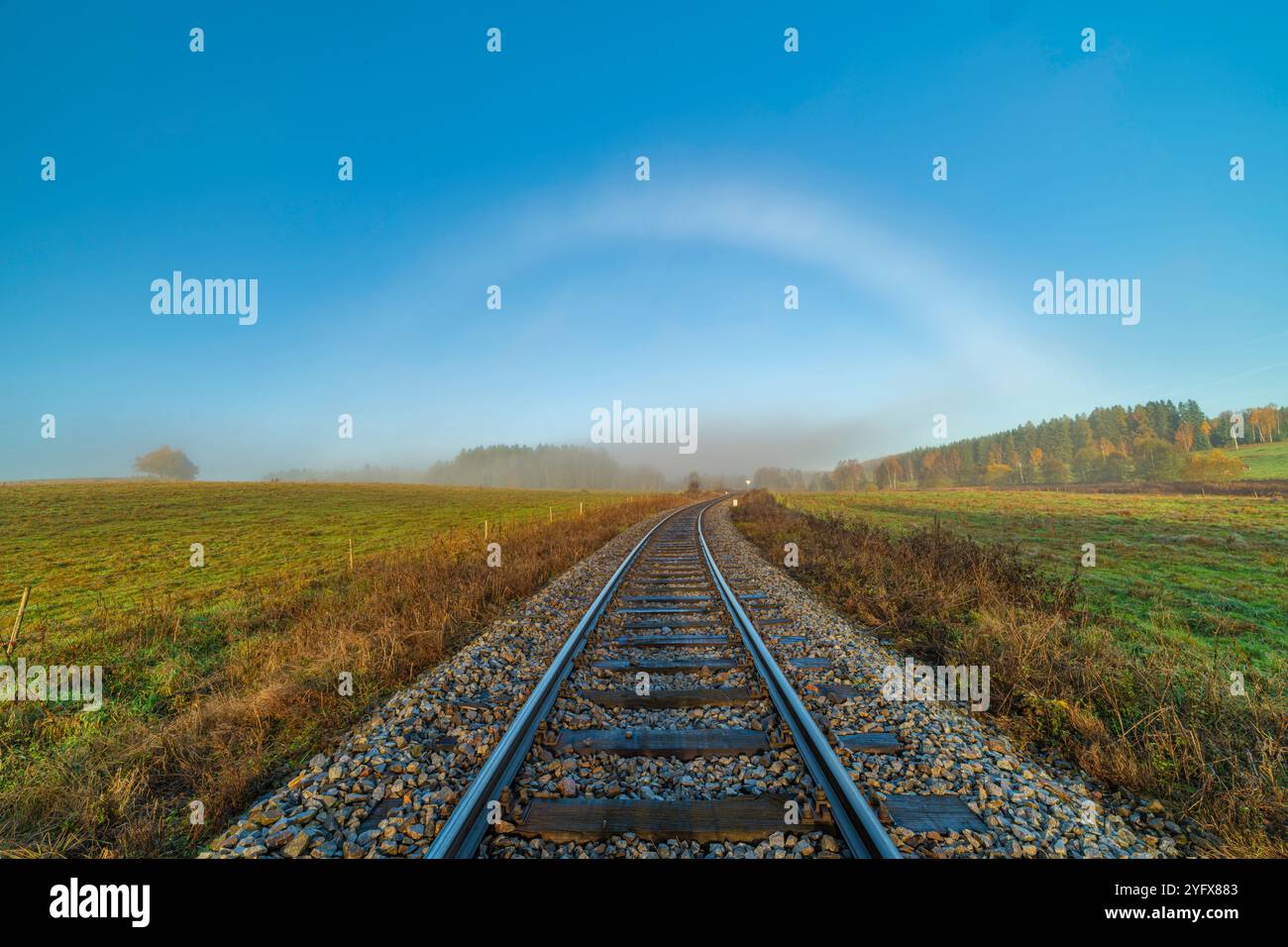 White rainbow over railway track in Sumava national park in cold autumn morning Stock Photo - Alamy