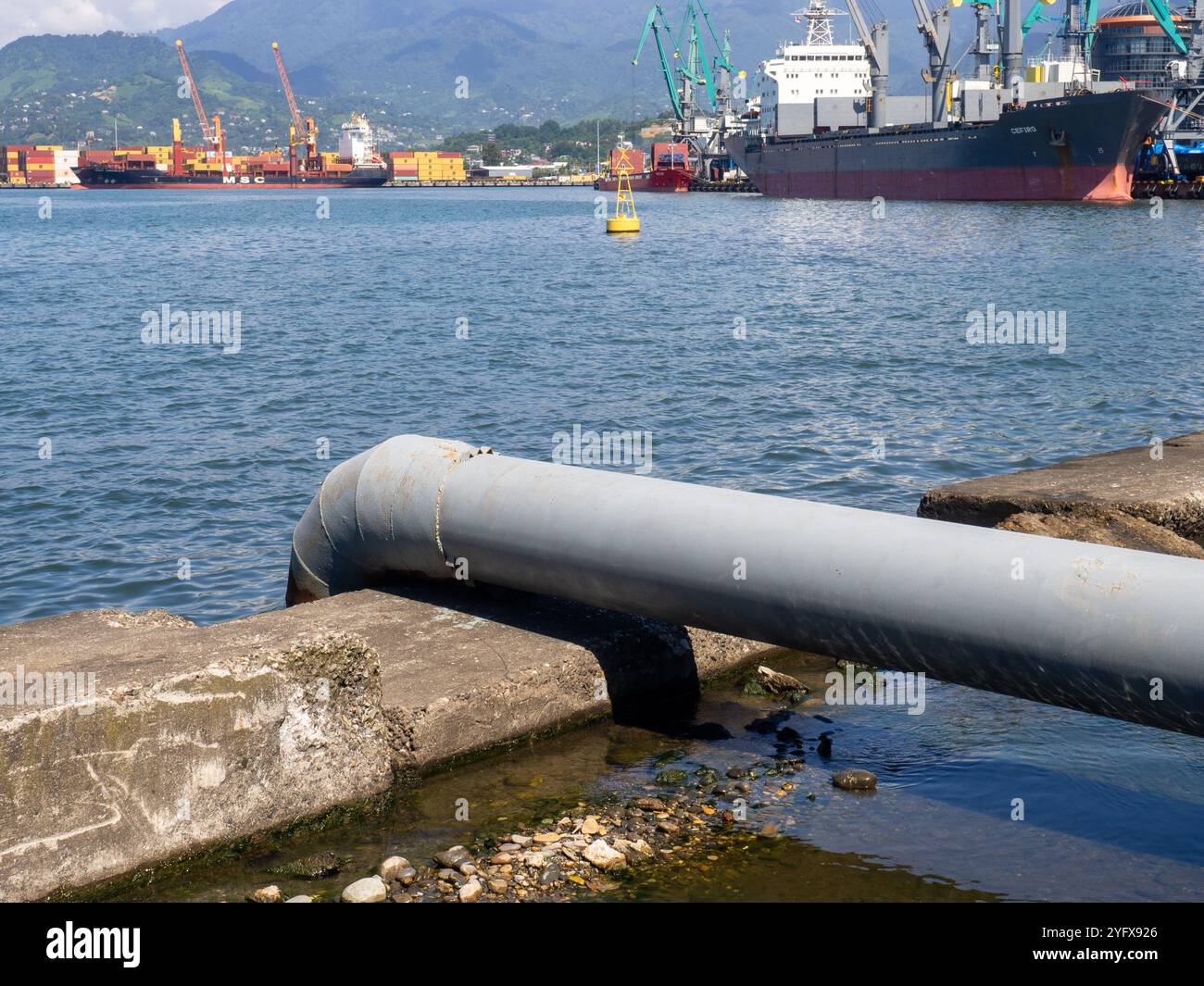 Pipe for draining sewage into the sea. Industrial zone. Environmental ...